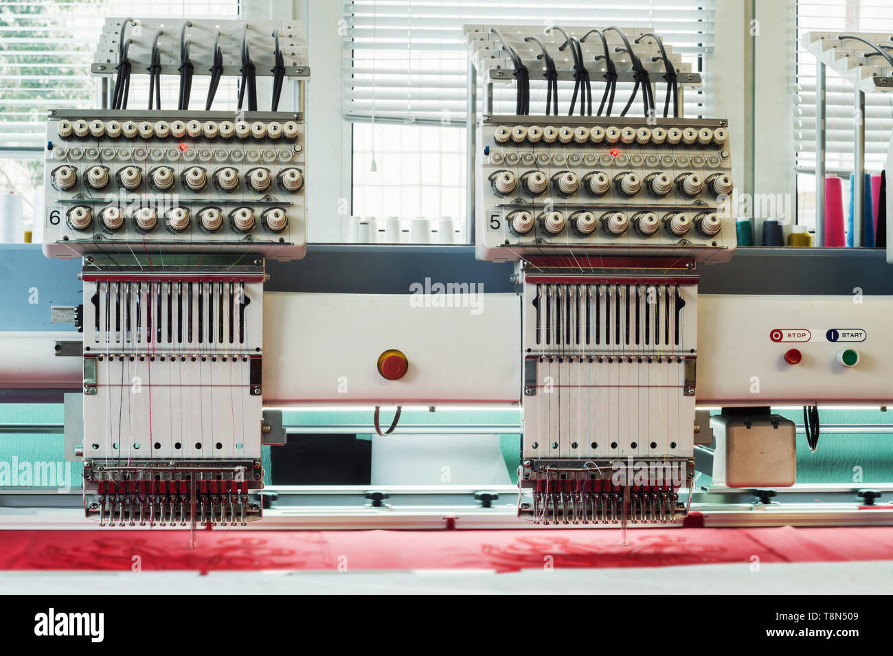 Industrial embroidery machine in textile production workshop Stock ...