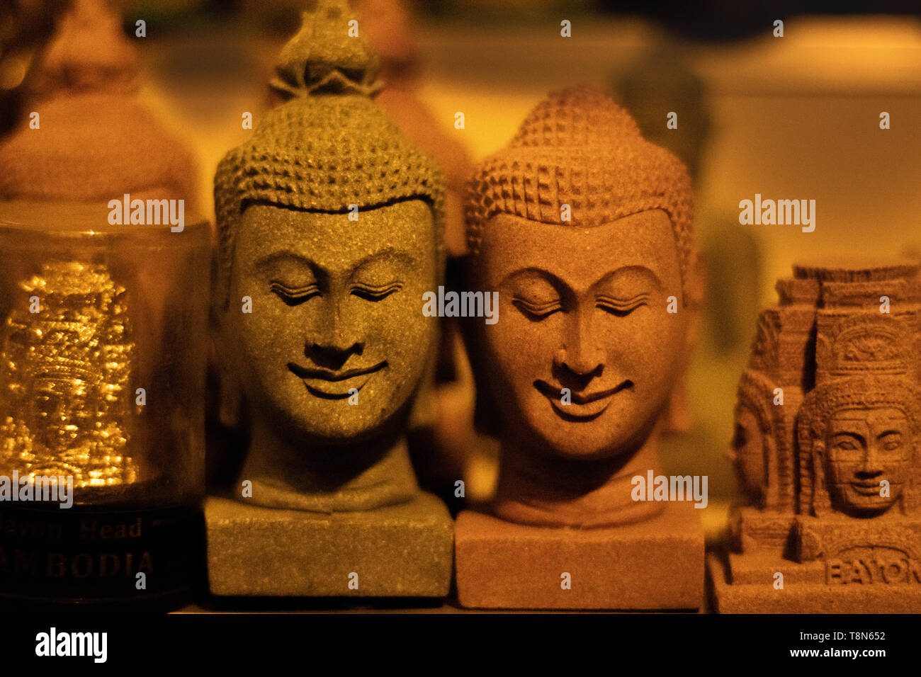 small Buddha heads, made out of stone Stock Photo - Alamy