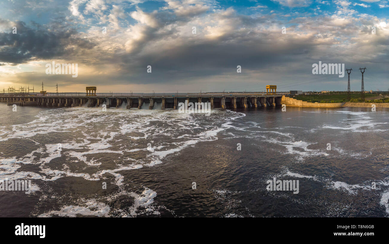 Powerful stream of water falls from the shutter in the dam ...