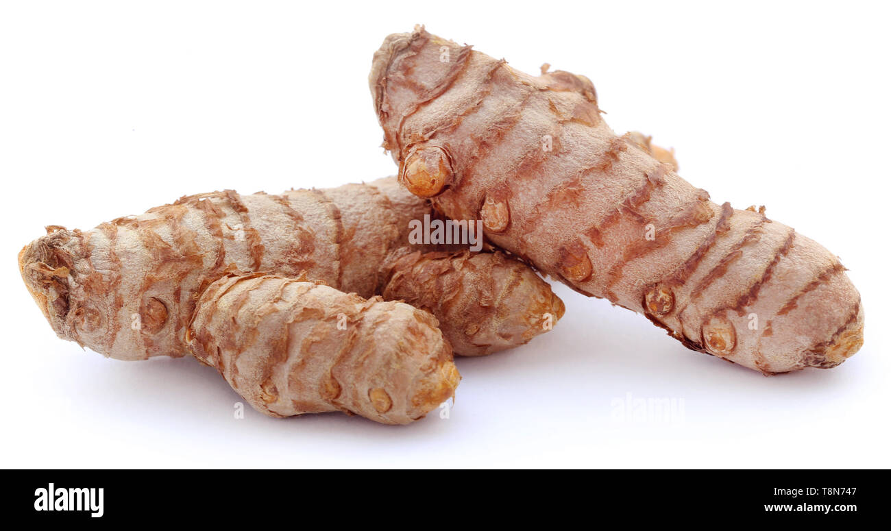 Raw turmeric over white background Stock Photo - Alamy