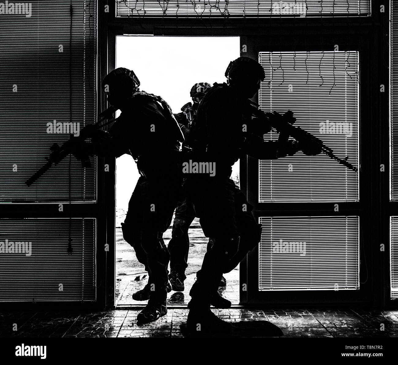 SWAT team breaching door and storming apartments Stock Photo - Alamy SWAT team breaching door and storming apartments Stock Photo - Alamy