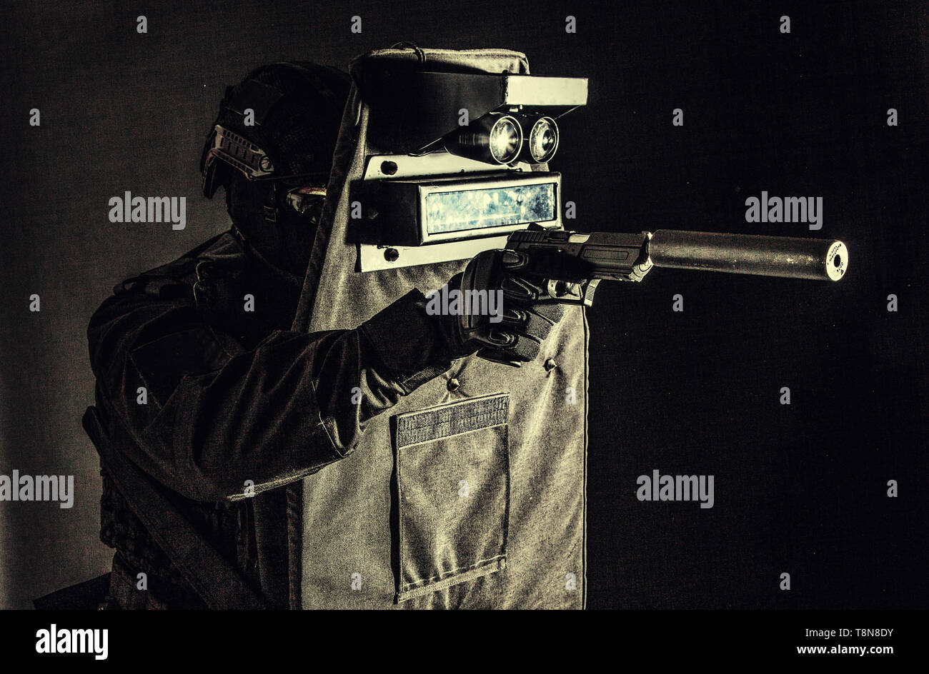 Armed SWAT fighter hiding behind ballistic shield Stock Photo - Alamy