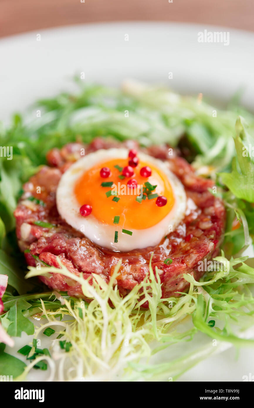 Beef tartare with egg in plate, close-up Stock Photo - Alamy