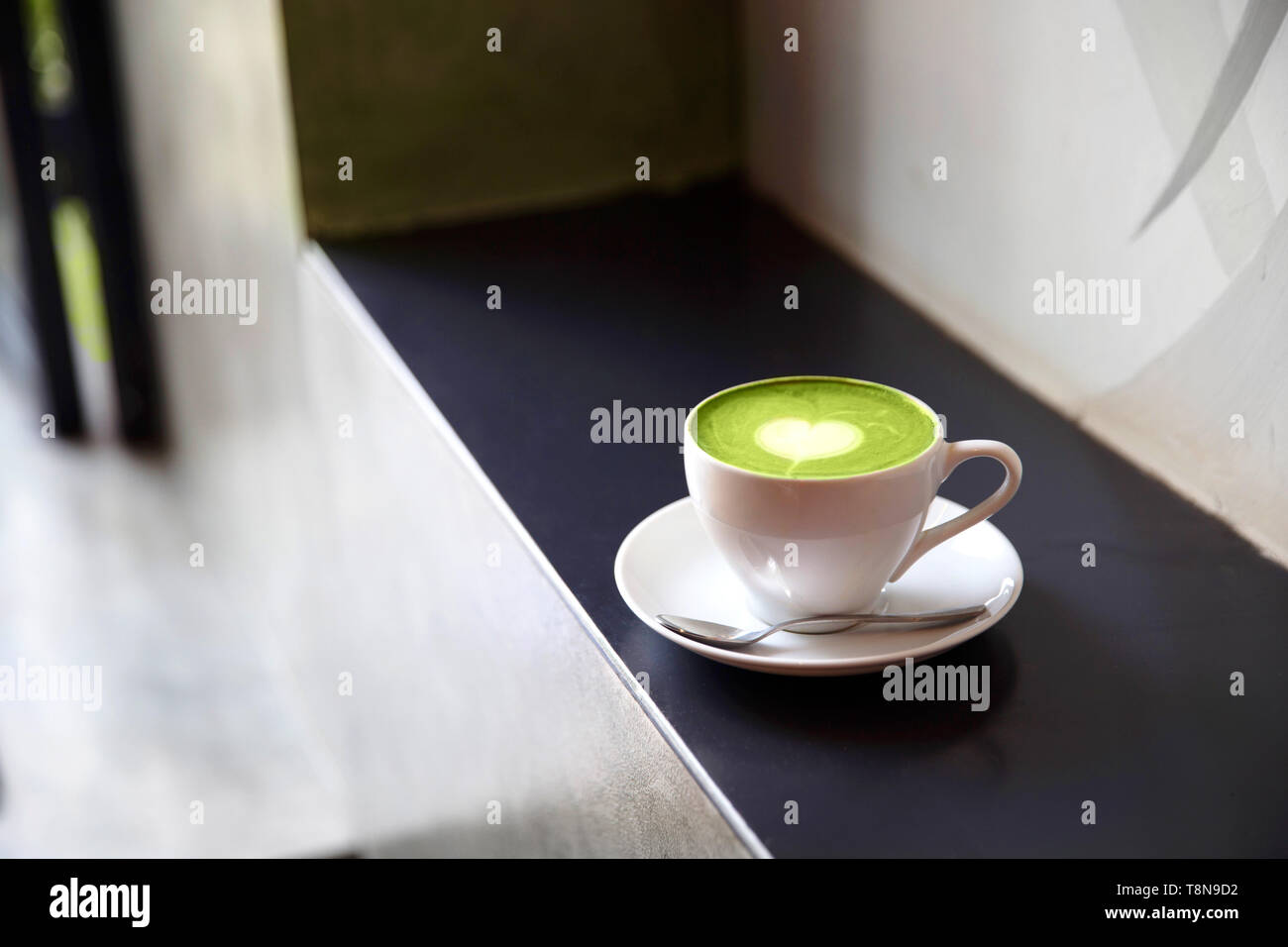 White cup of tasty matcha latte with love art. Valentine's concept ...