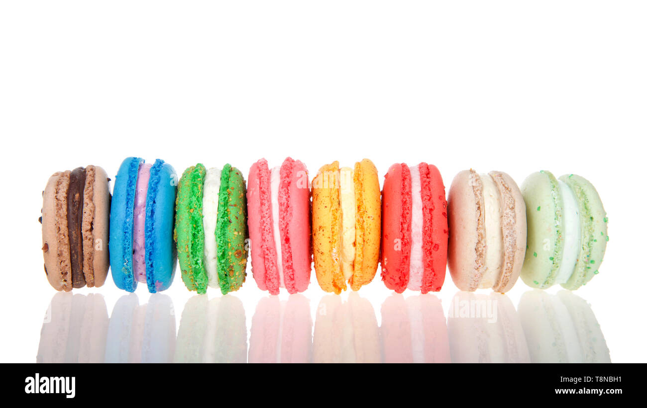 Row of macaron cookies laying sideways side by side multiple colors and ...