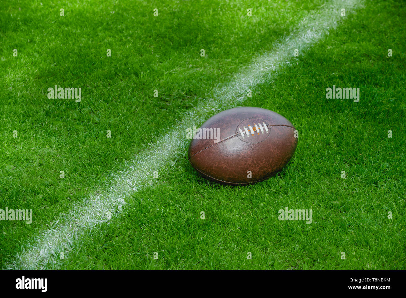 American football, rugby ball on green grass field background Stock ...