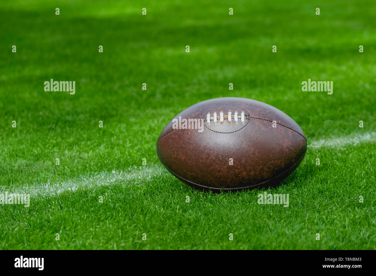 American football, rugby ball on green grass field background Stock ...