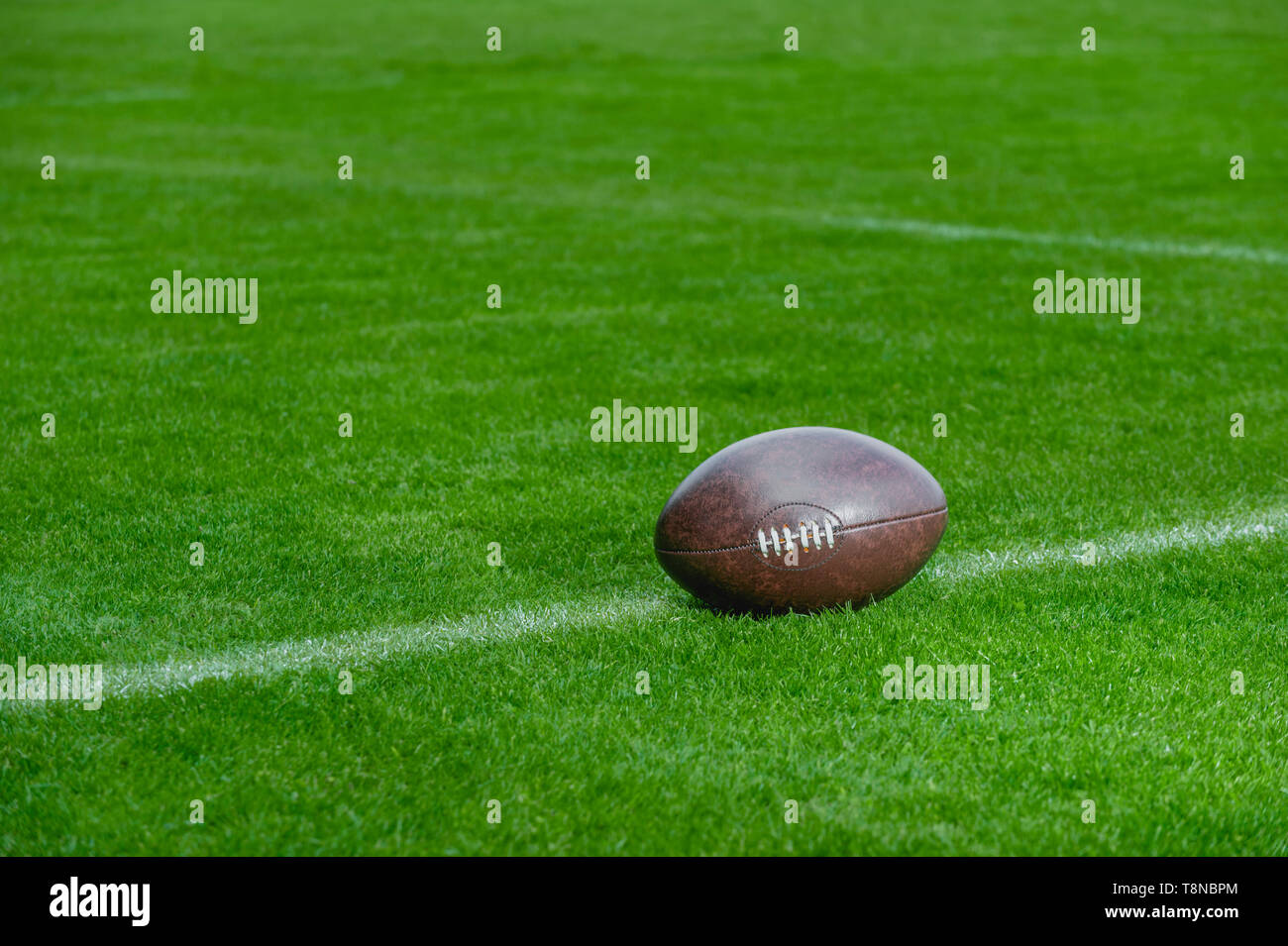 American football, rugby ball on green grass field background Stock ...