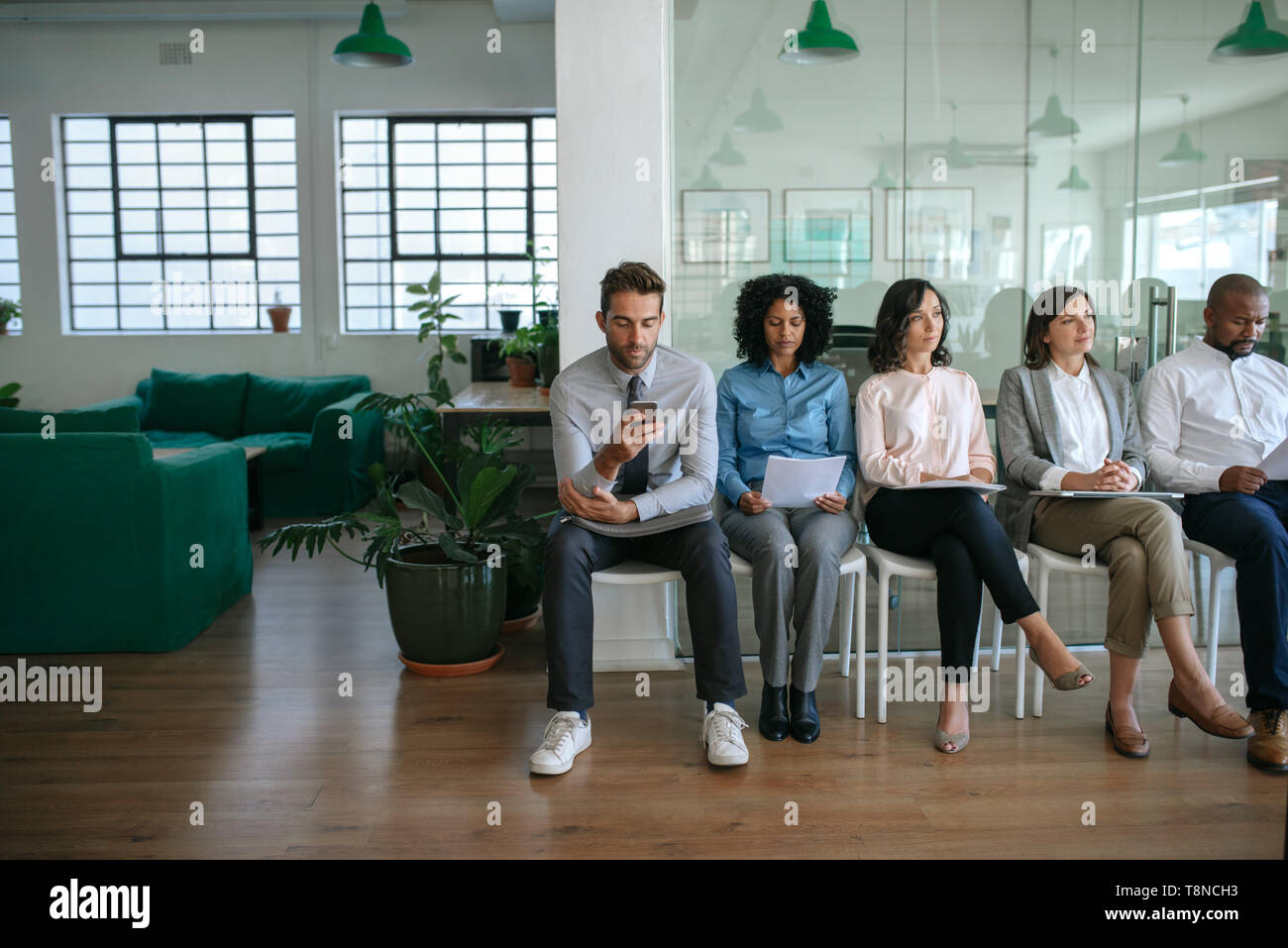 People sitting in an office waiting for job interviews Stock Photo - Alamy