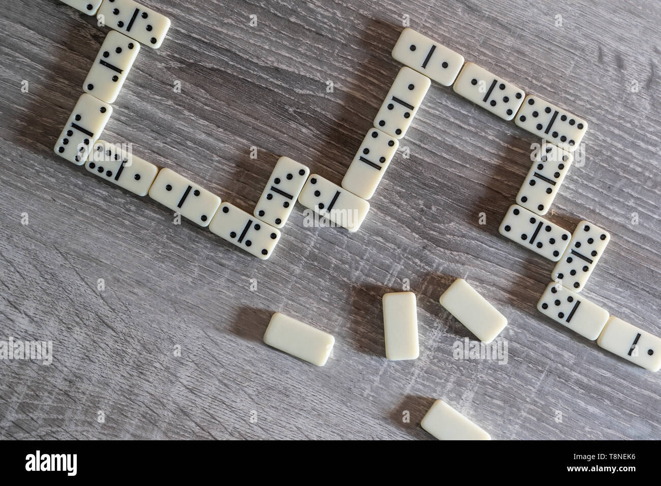 the pieces of the game of dominoes on the wooden table Stock Photo - Alamy
