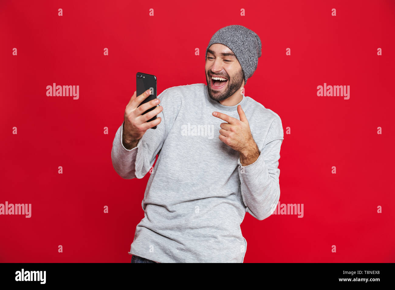 Image of european man 30s with beard and mustache holding smartphone ...