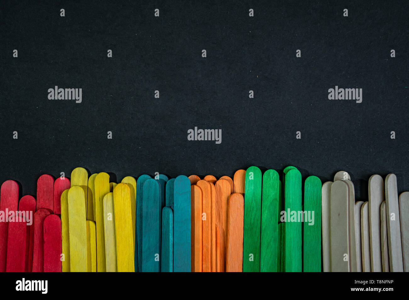 Colorful sticks isolated on black background Stock Photo - Alamy