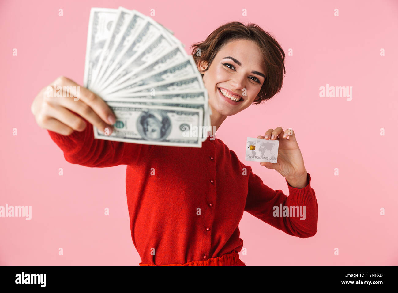 Portrait of a beautiful young woman wearing red clothes standing ...