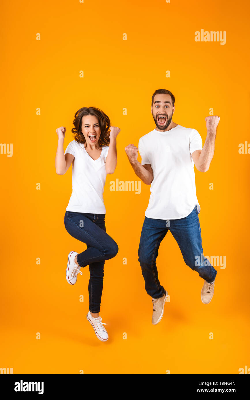 Full length photo of cheerful couple screaming in surprise while ...
