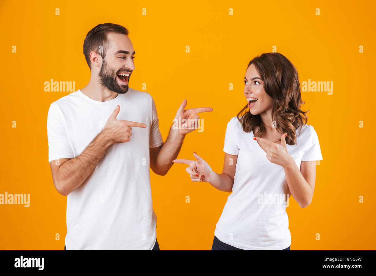 Portrait of caucasian people man and woman in basic clothing pointing ...