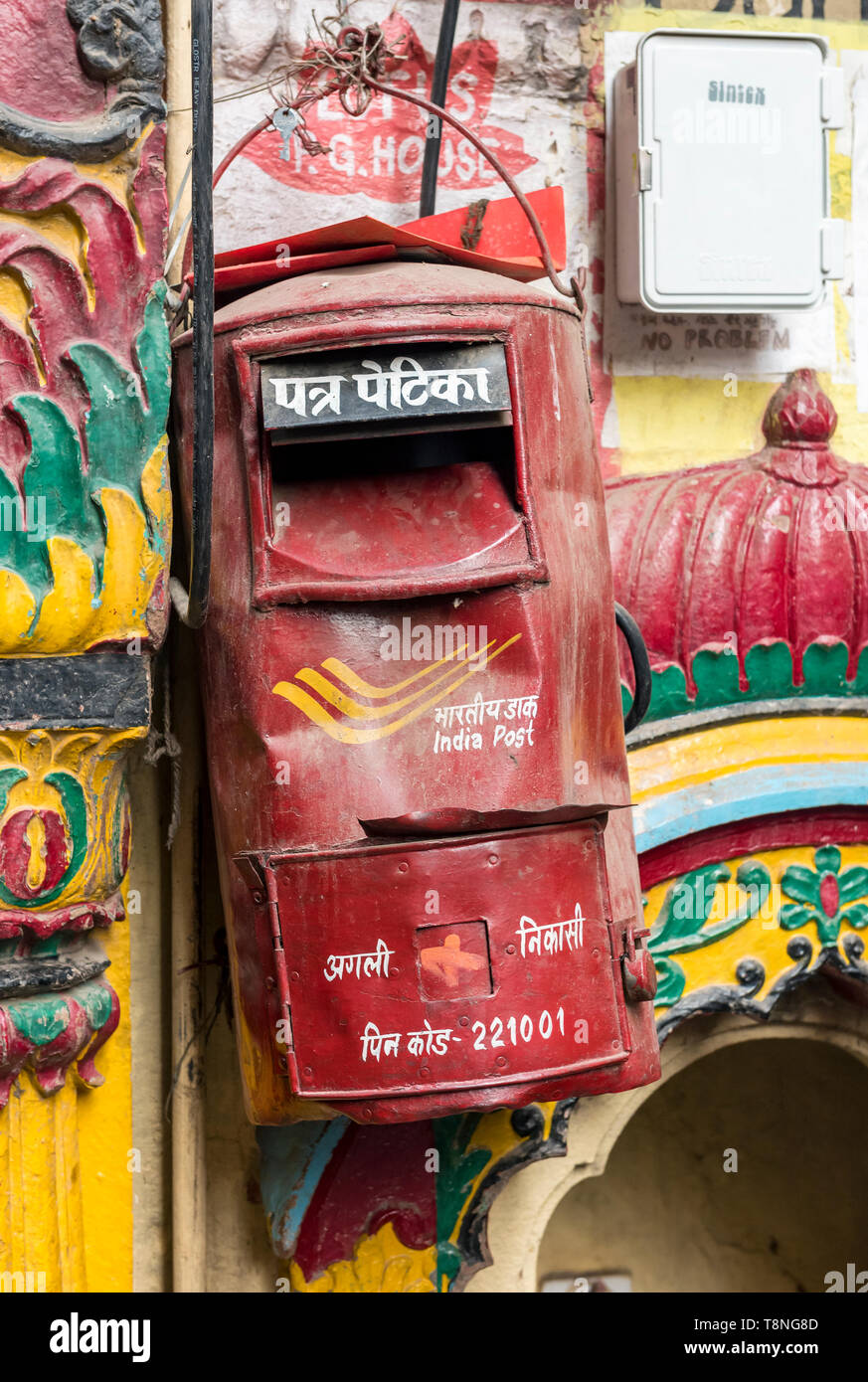 Old red post box on colourful wall of a Hindu temple in the Old City of ...