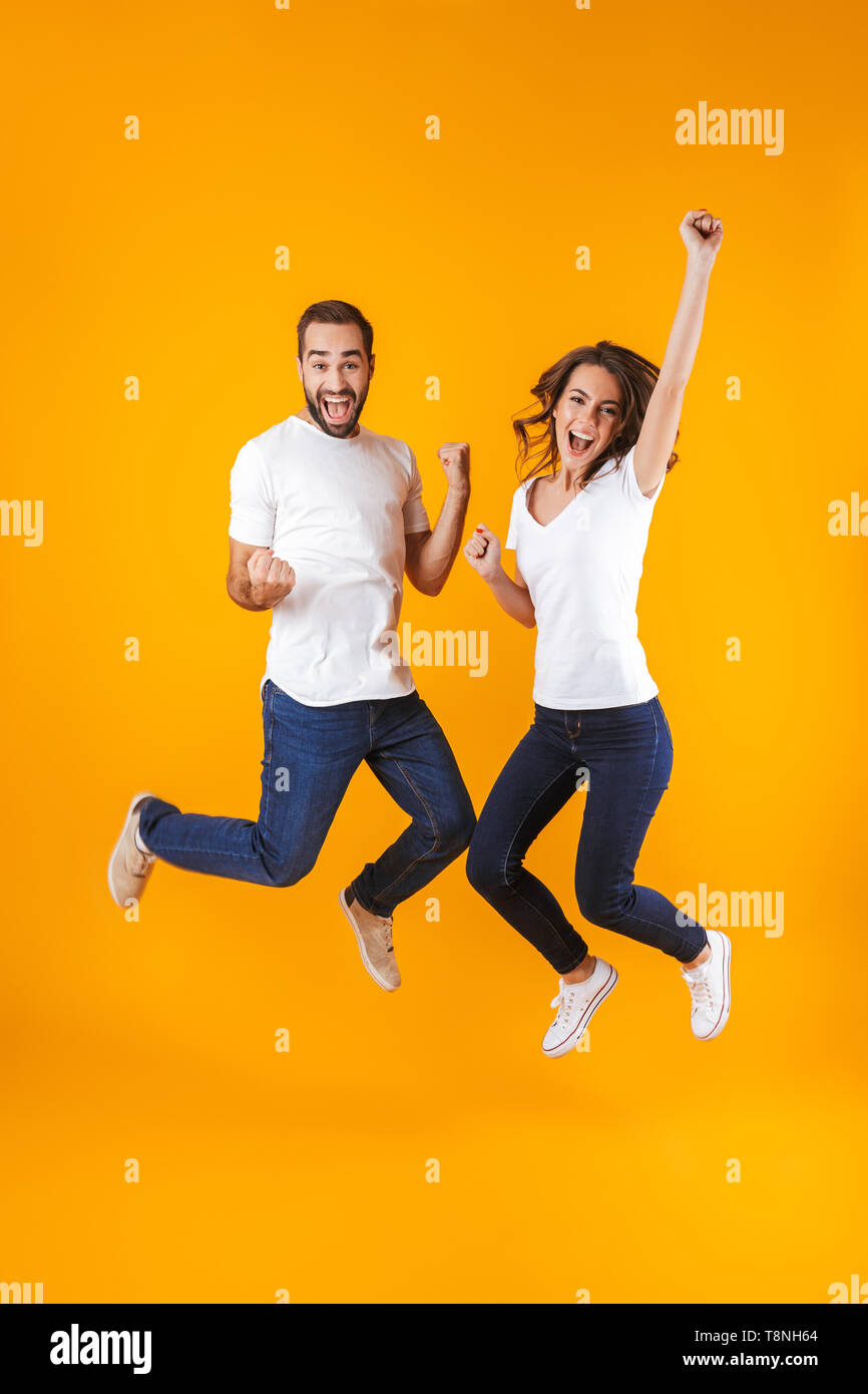 Full length photo of rejoicing couple screaming in surprise while ...