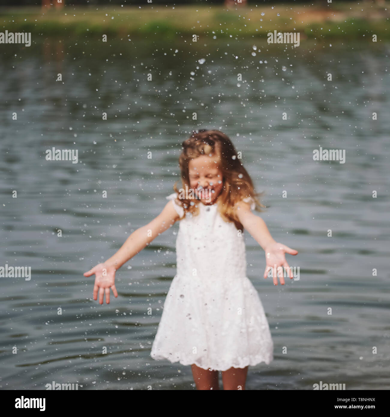 cute happy little girls in sumer lake Stock Photo - Alamy