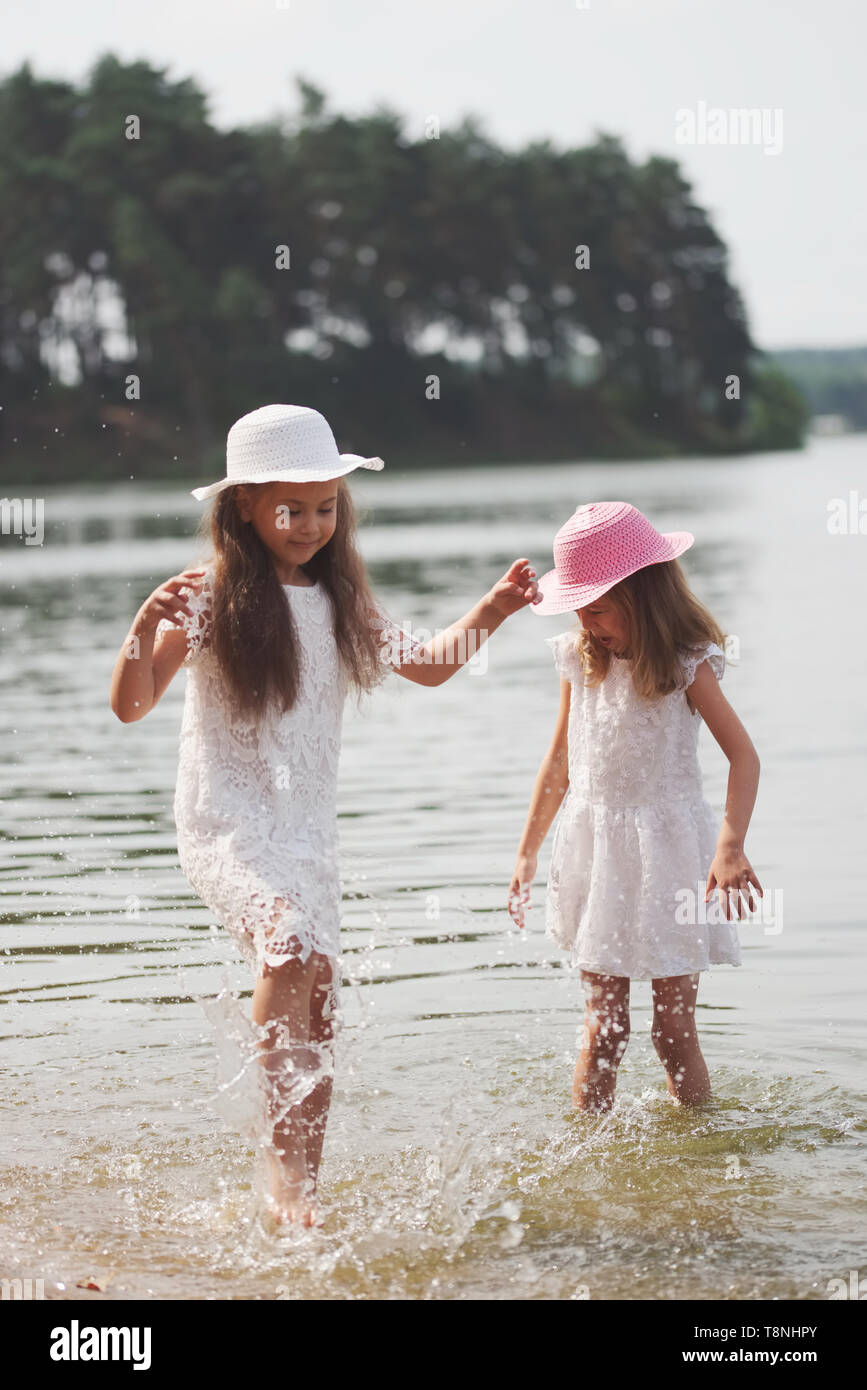 cute happy little girls in sumer lake Stock Photo - Alamy
