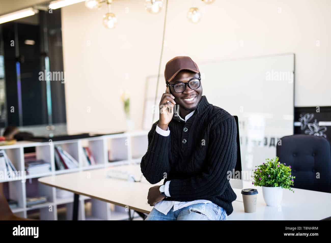 Mobile phone talk. Young black businessman has mobile phone call in ...