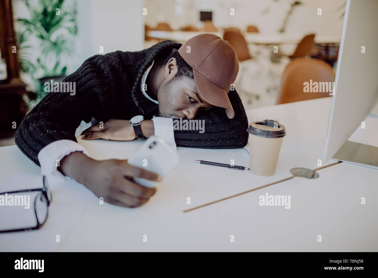 working man exhausted and sleeping on laptop with mobile phone at ...