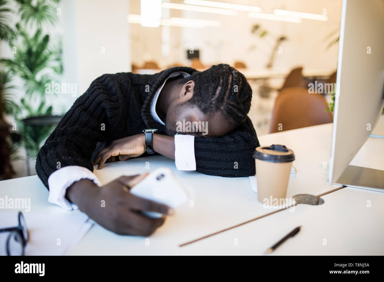 working man exhausted and sleeping on laptop with mobile phone at ...