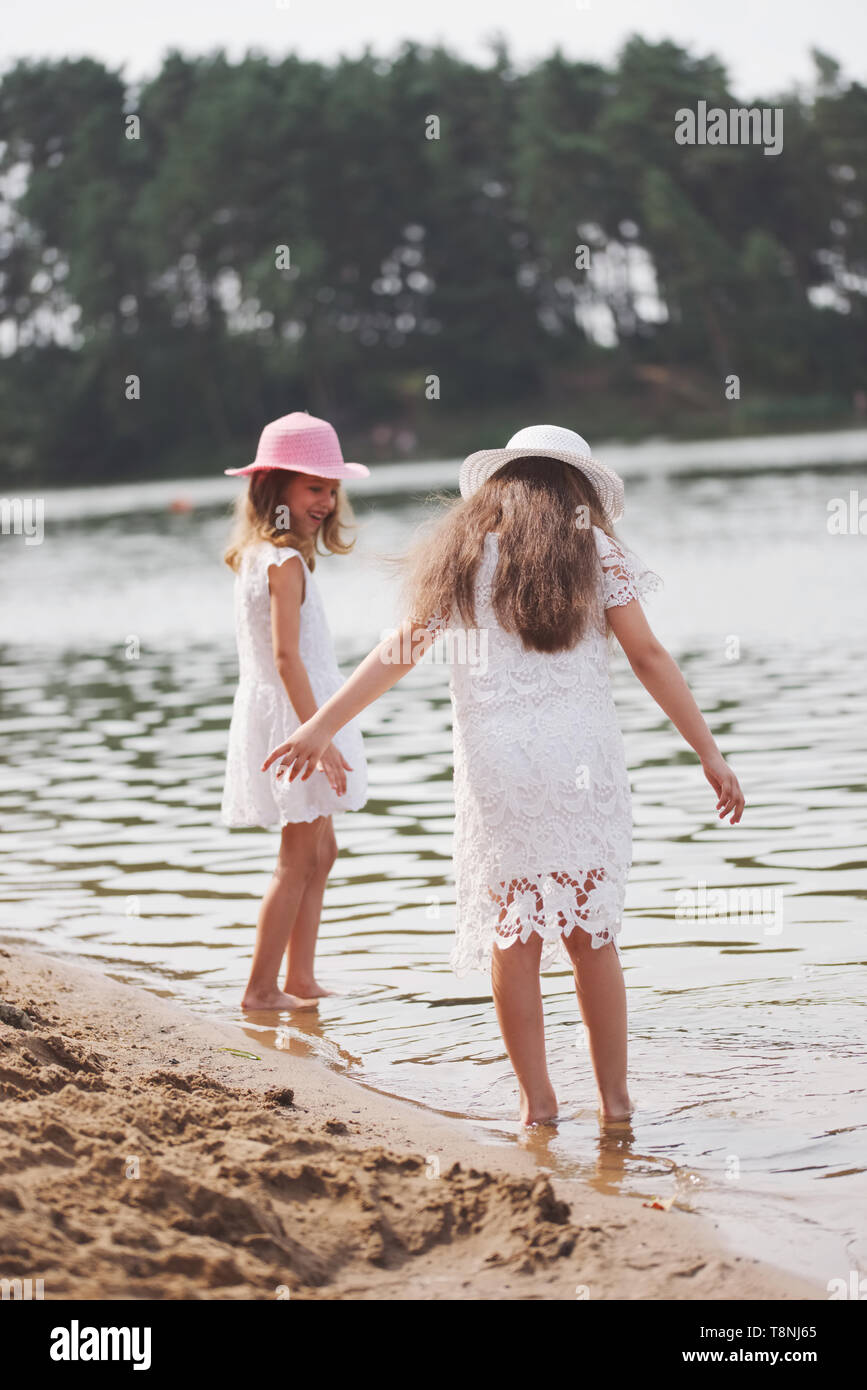 cute happy little girls in sumer lake Stock Photo - Alamy
