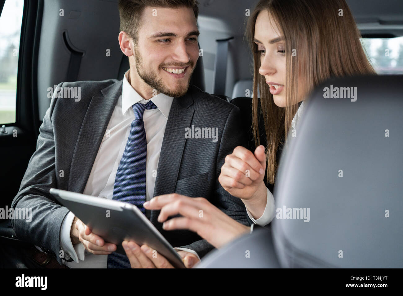 Conversation of two business people in driving car Stock Photo - Alamy