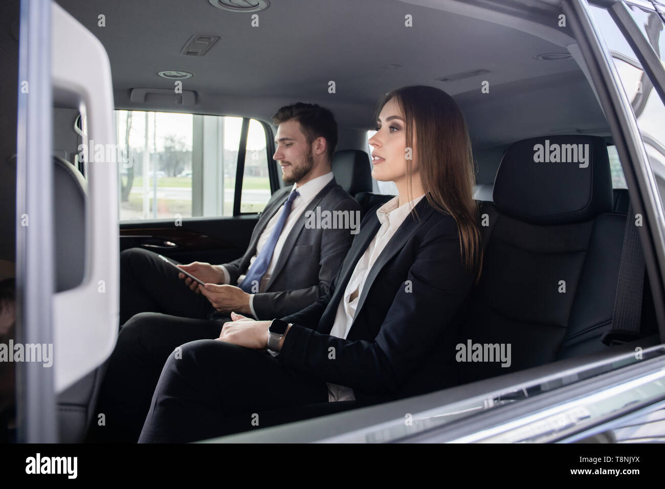 Conversation of two business people in driving car Stock Photo - Alamy
