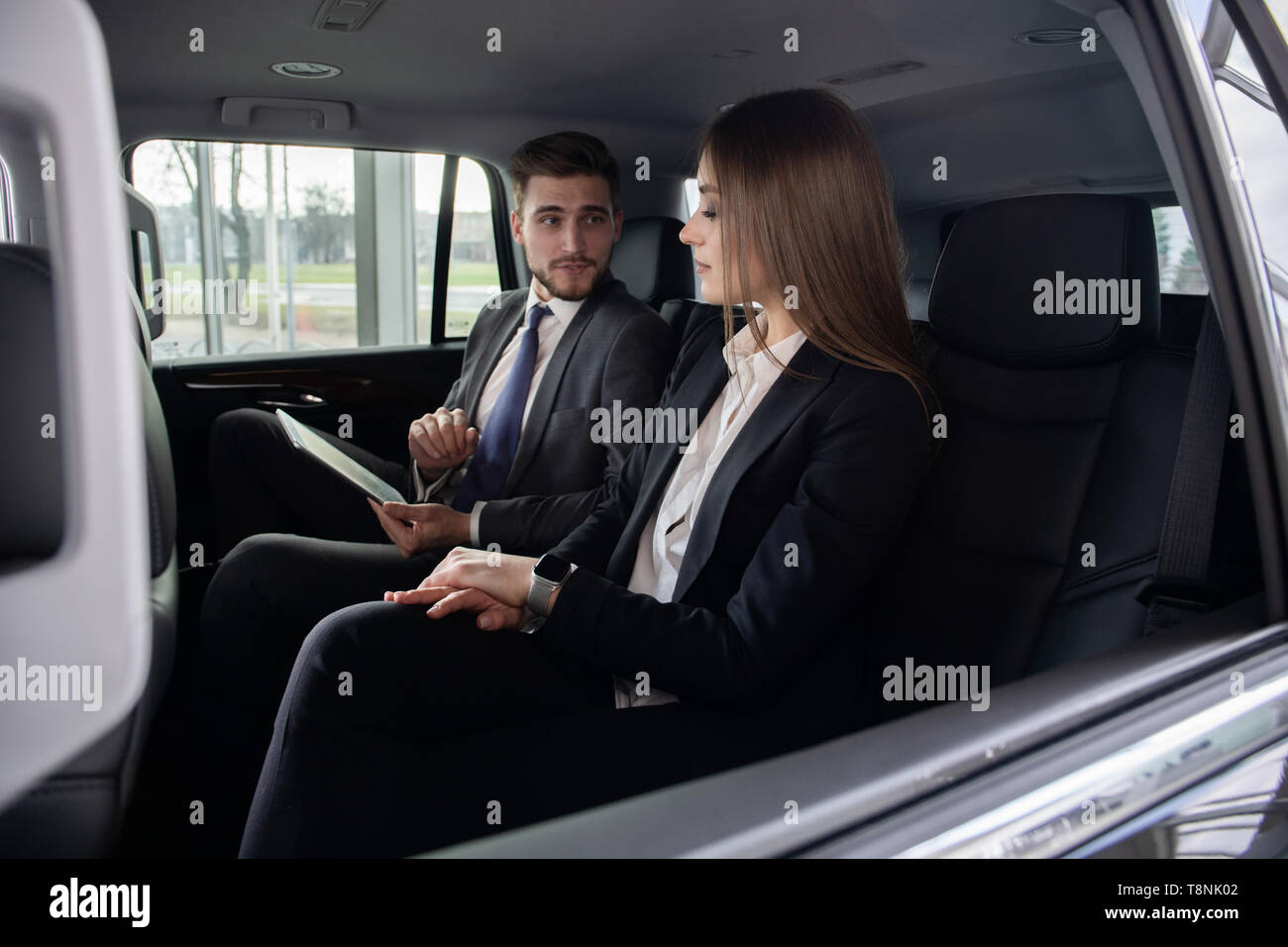 Conversation of two business people in driving car Stock Photo - Alamy