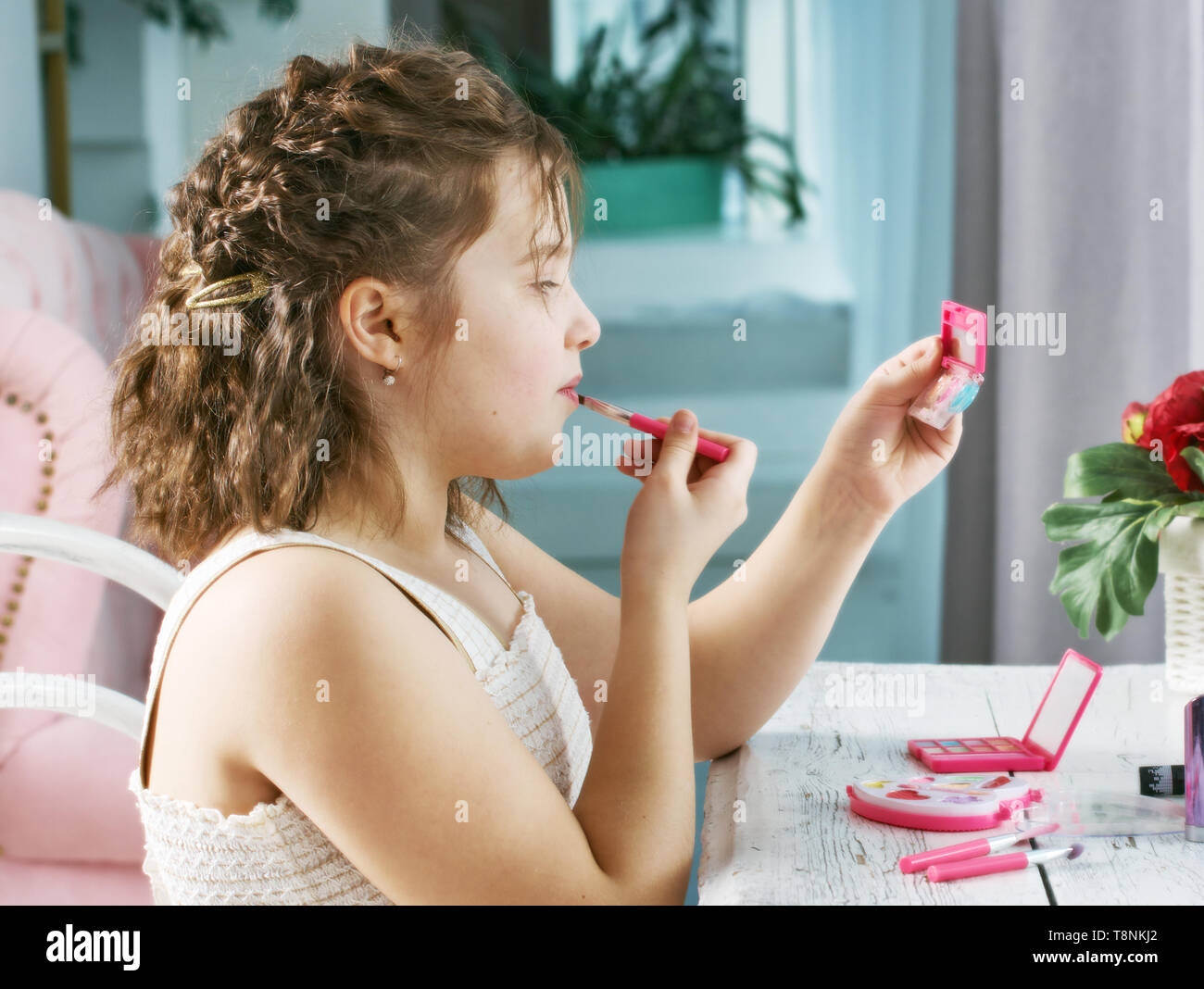 Portrait of little cute girl makes children's makeup at home Stock ...