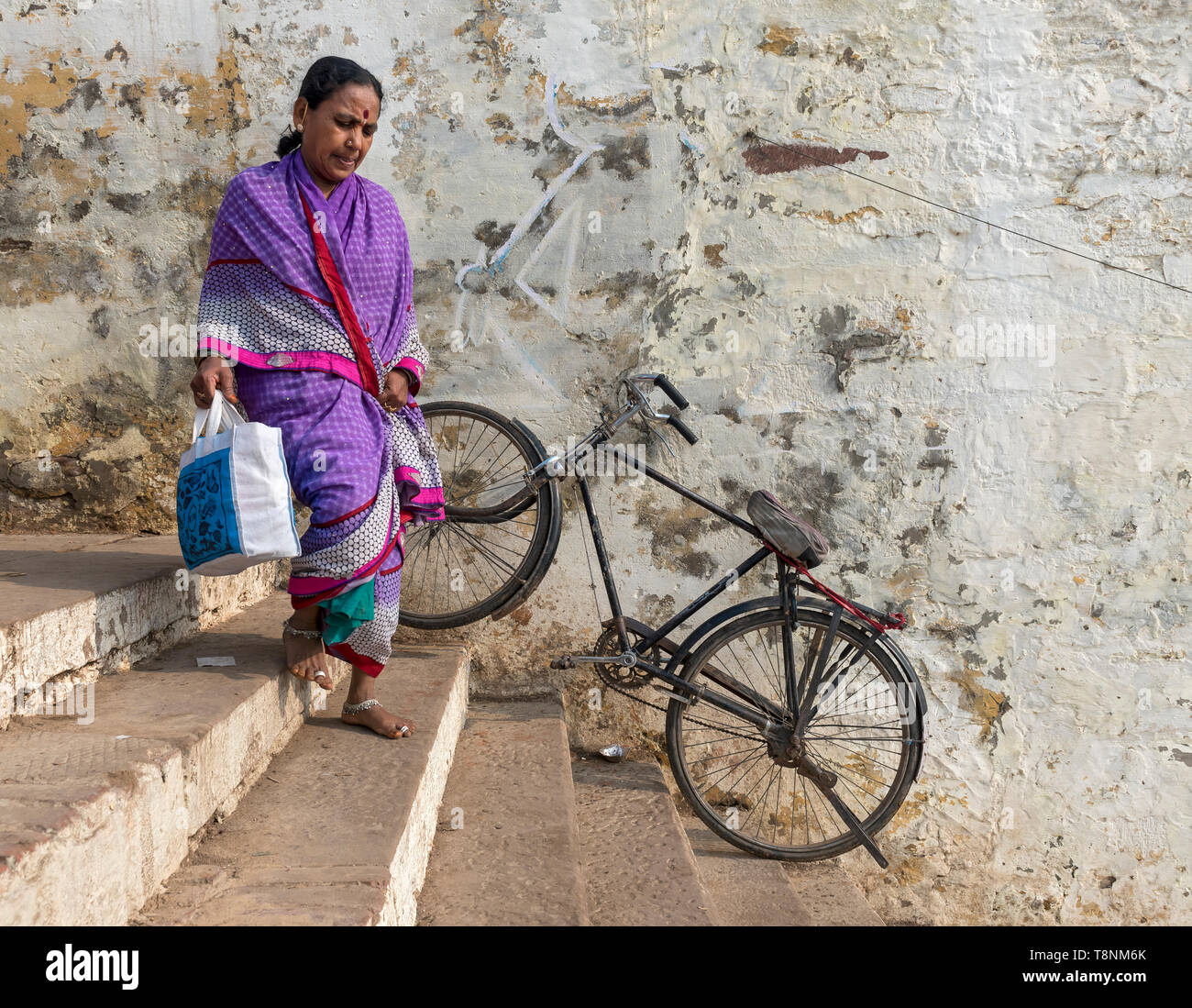 Woman descends steps (ghats) to the River Ganges, Vranasi, India Stock ...