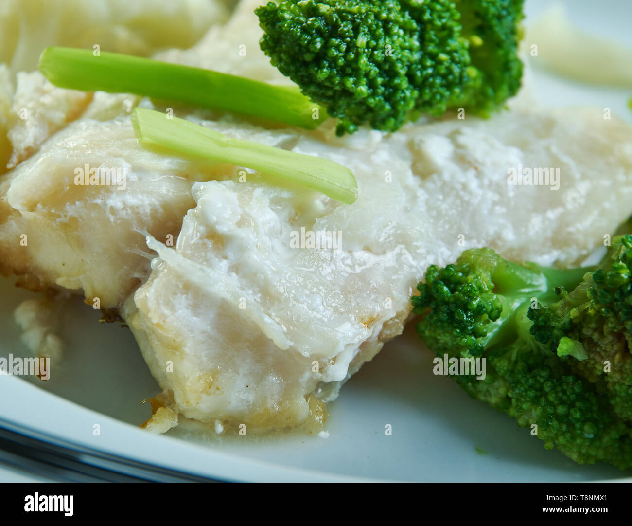 Poached hake served with vinaigrette, close up Stock Photo - Alamy