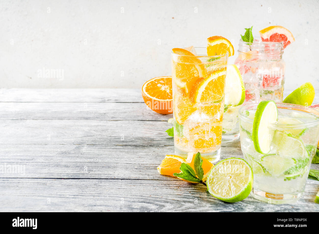 Summer refreshment drinks. Four types of citrus lemonade or mojito ...