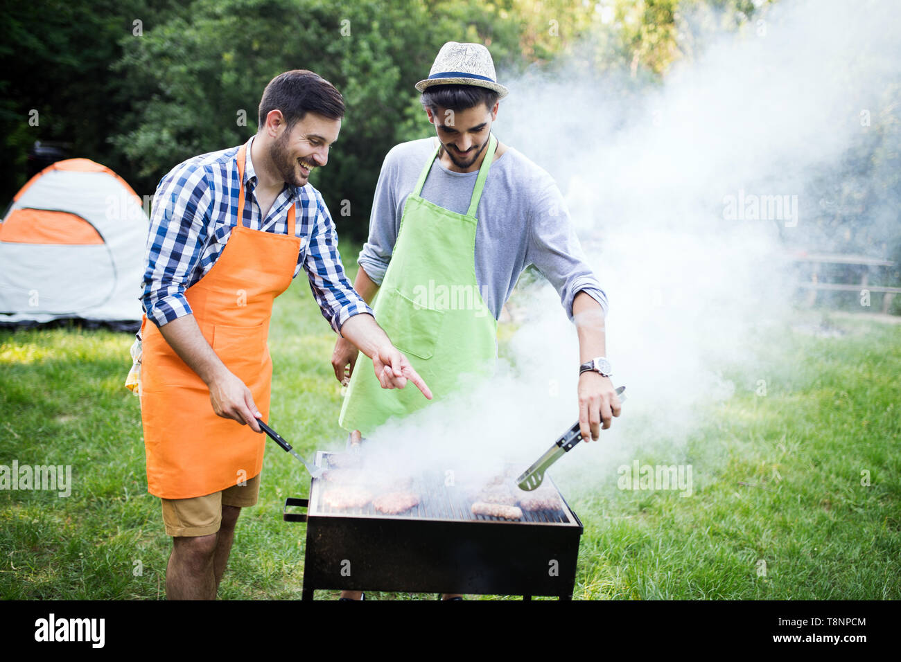 Friends having a barbecue party in nature Stock Photo - Alamy