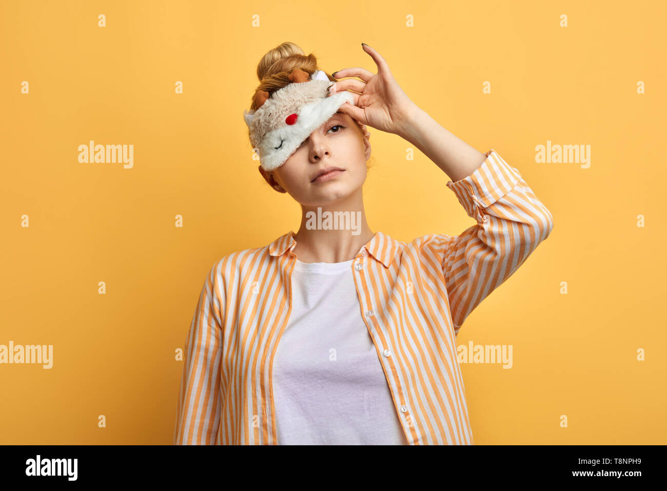 lovely sleepy lady looking through the eyemask . close up portrait ...