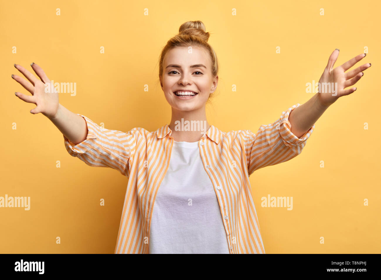 friendly kind smiling woman with an open hand ready for hugging ...
