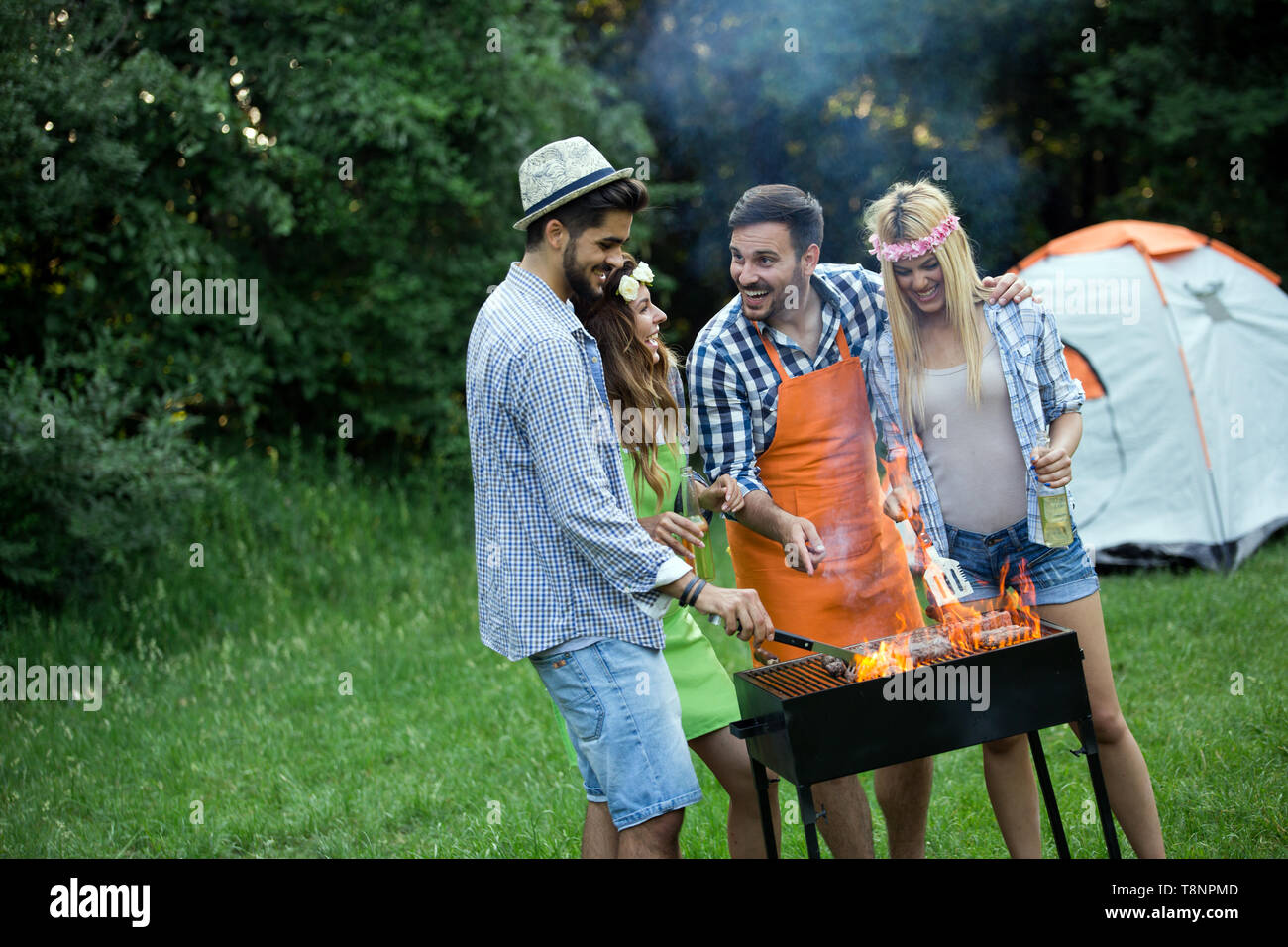 Group of friends having fun in nature doing bbq Stock Photo - Alamy