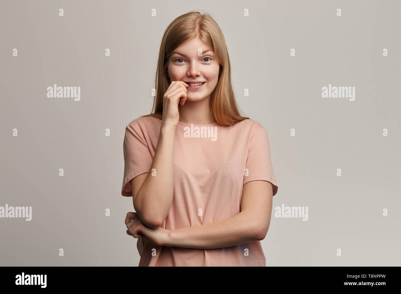 nervous emotional beautiful girl in beige T-shirt feels anxious and ...