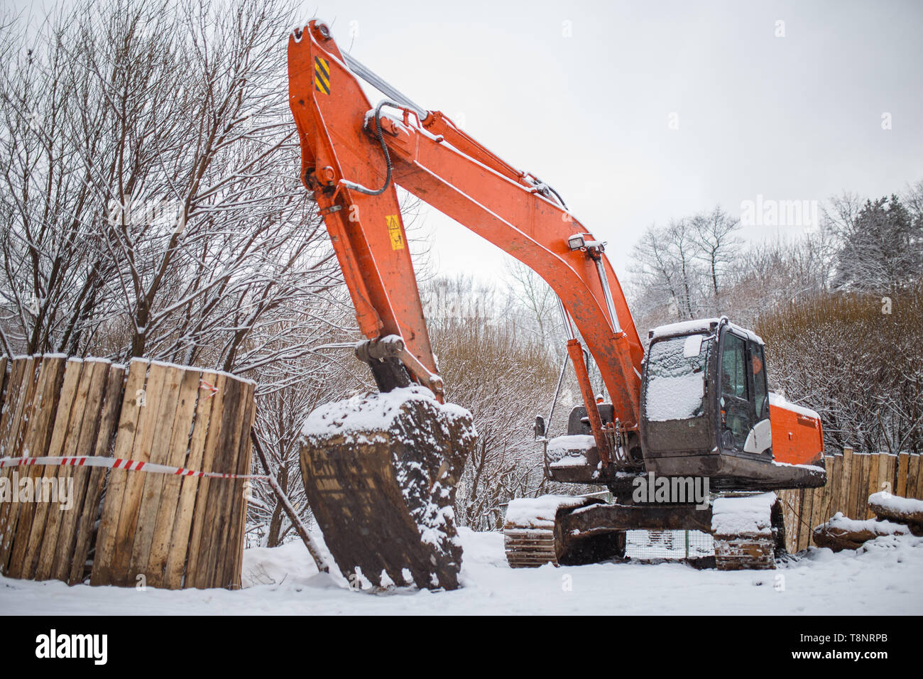 Photo of working excavator in winter day Stock Photo - Alamy