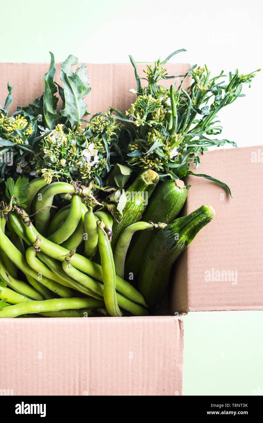 Green vegetables and herbs in cardboard box. Healthy organic food ...
