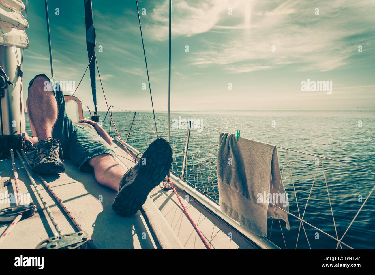 Water traveling, adventure concept. Man relaxing lying on sporty yacht ...