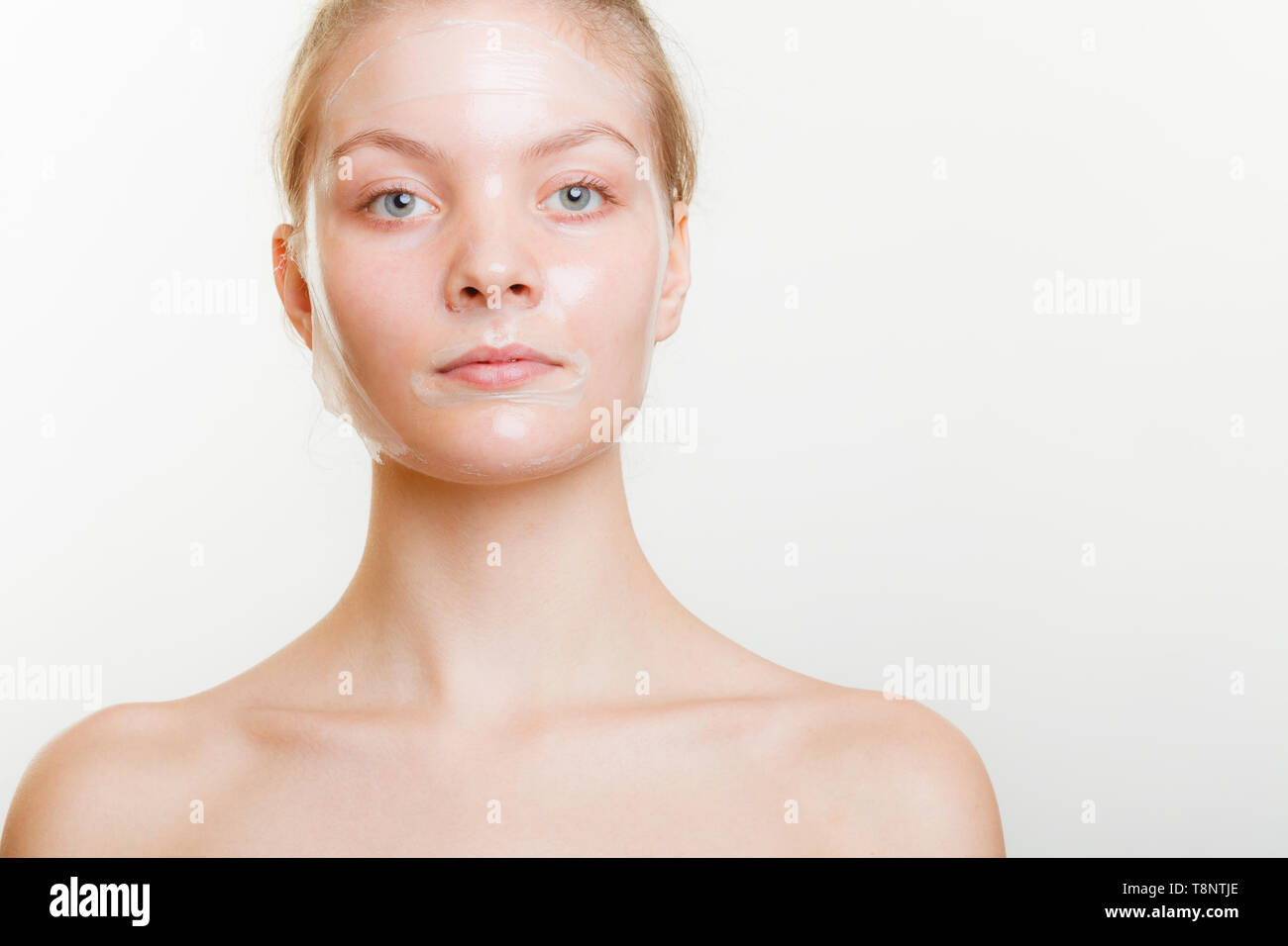 Young woman in facial peel off mask. Peeling. Beauty and skin care ...