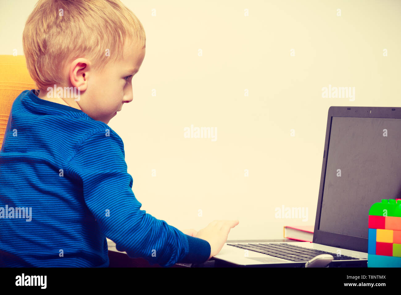 Children and technology, spending free time online concept. Little boy ...