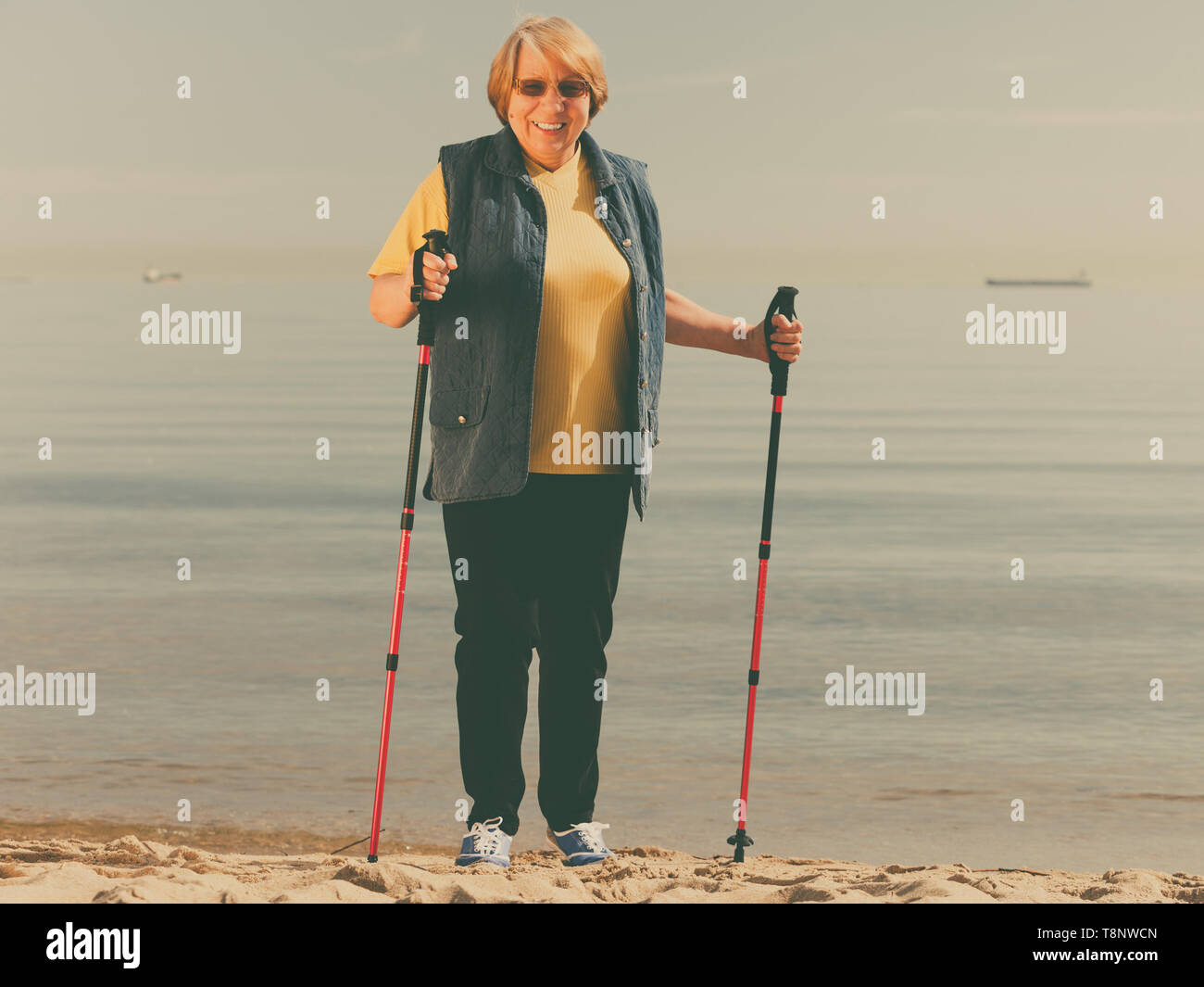 Healthy lifestyle in old age. Senior woman practicing nordic walking on ...