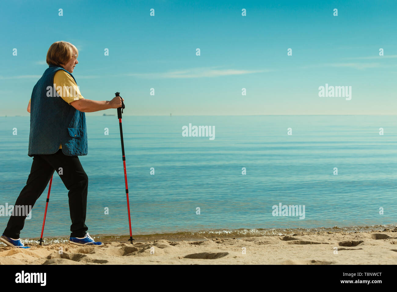 Healthy lifestyle in old age. Senior woman practicing nordic walking on ...