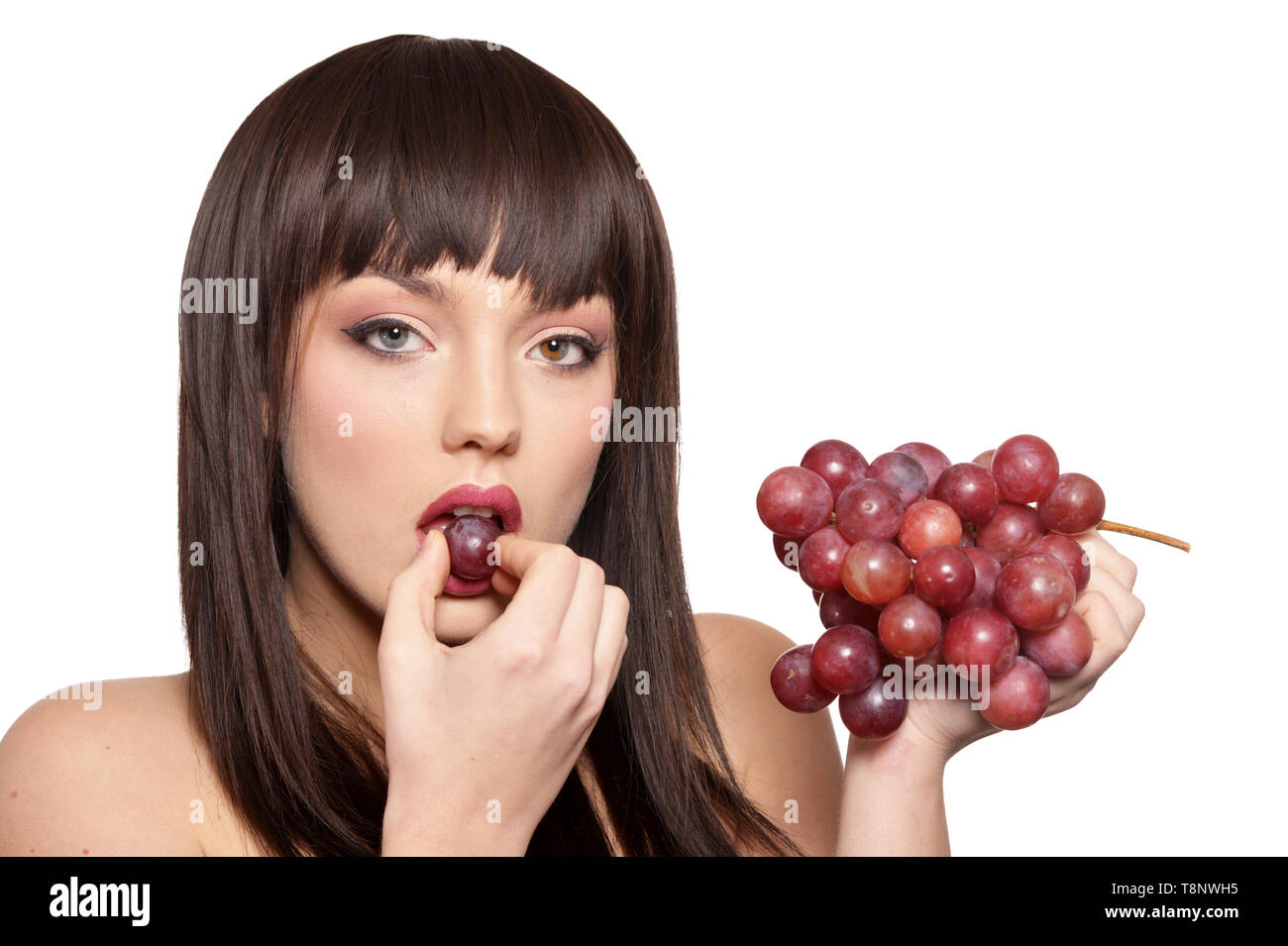 Young woman posing with grapes isolated on white background Stock Photo ...