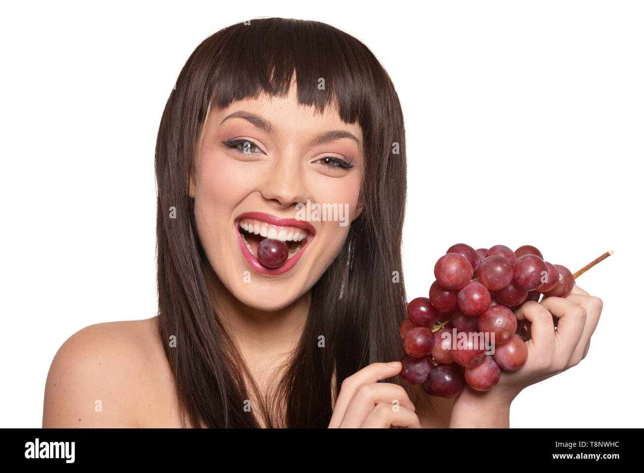 Young woman posing with grapes isolated on white background Stock Photo ...