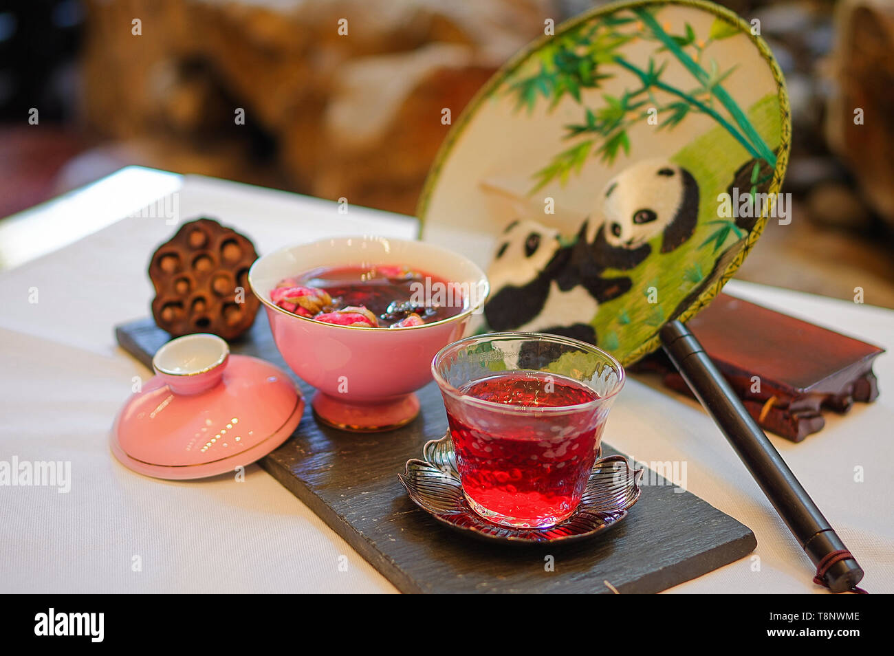 Scented tea in pink porcelain and glass cup decorated with lotus and ...