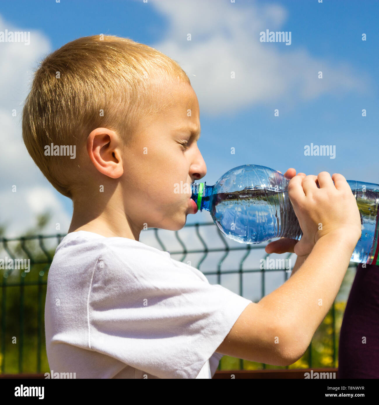 Little thirsty boy child drink water from plastic bottle, outdoor Stock ...